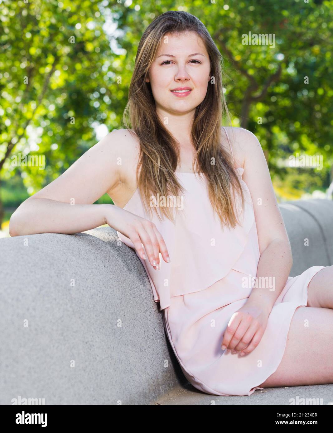Young girl is resting on the bench Stock Photo - Alamy