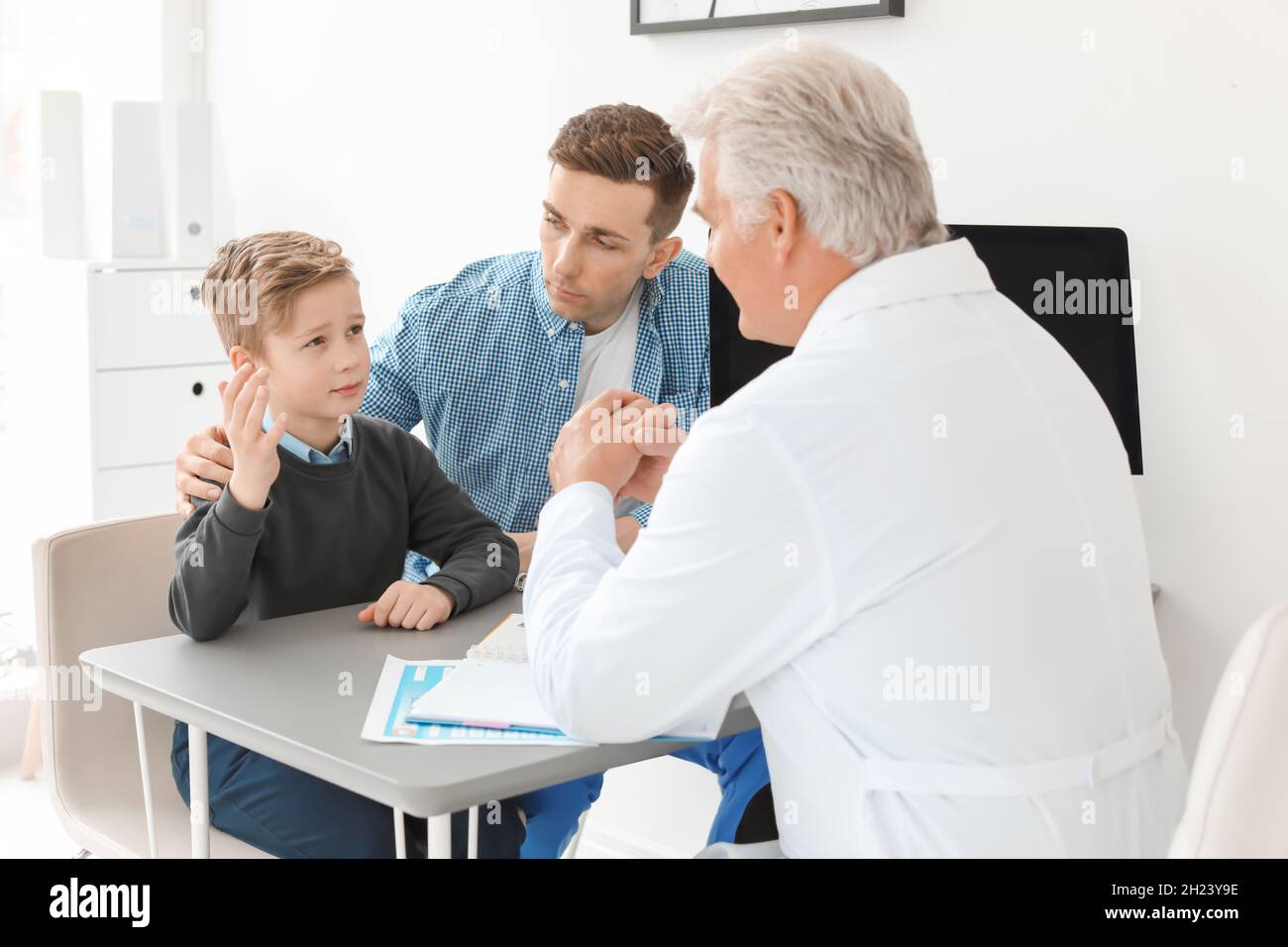 Young man with his son having appointment at child psychologist office ...