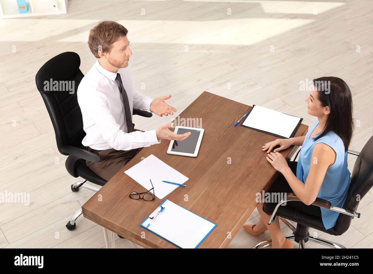 Human resources manager conducting job interview with applicant in office Stock Photo - Alamy