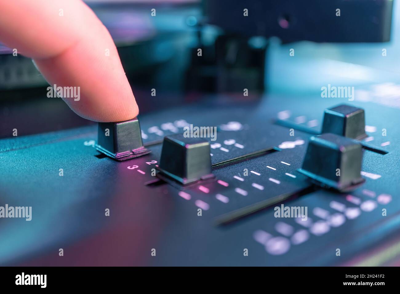 Dj is mixing sound and adjusting volume on audio control panel Stock ...