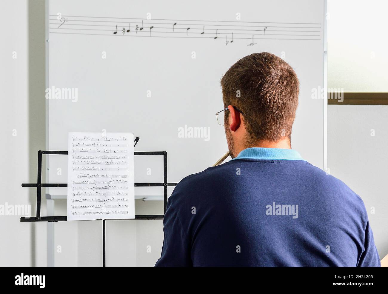 Young student studies lesson on sheet music in the classroom Stock ...