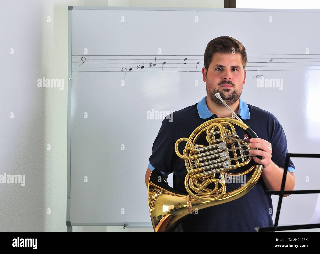 Young student studies lesson on sheet music in the classroom Stock ...