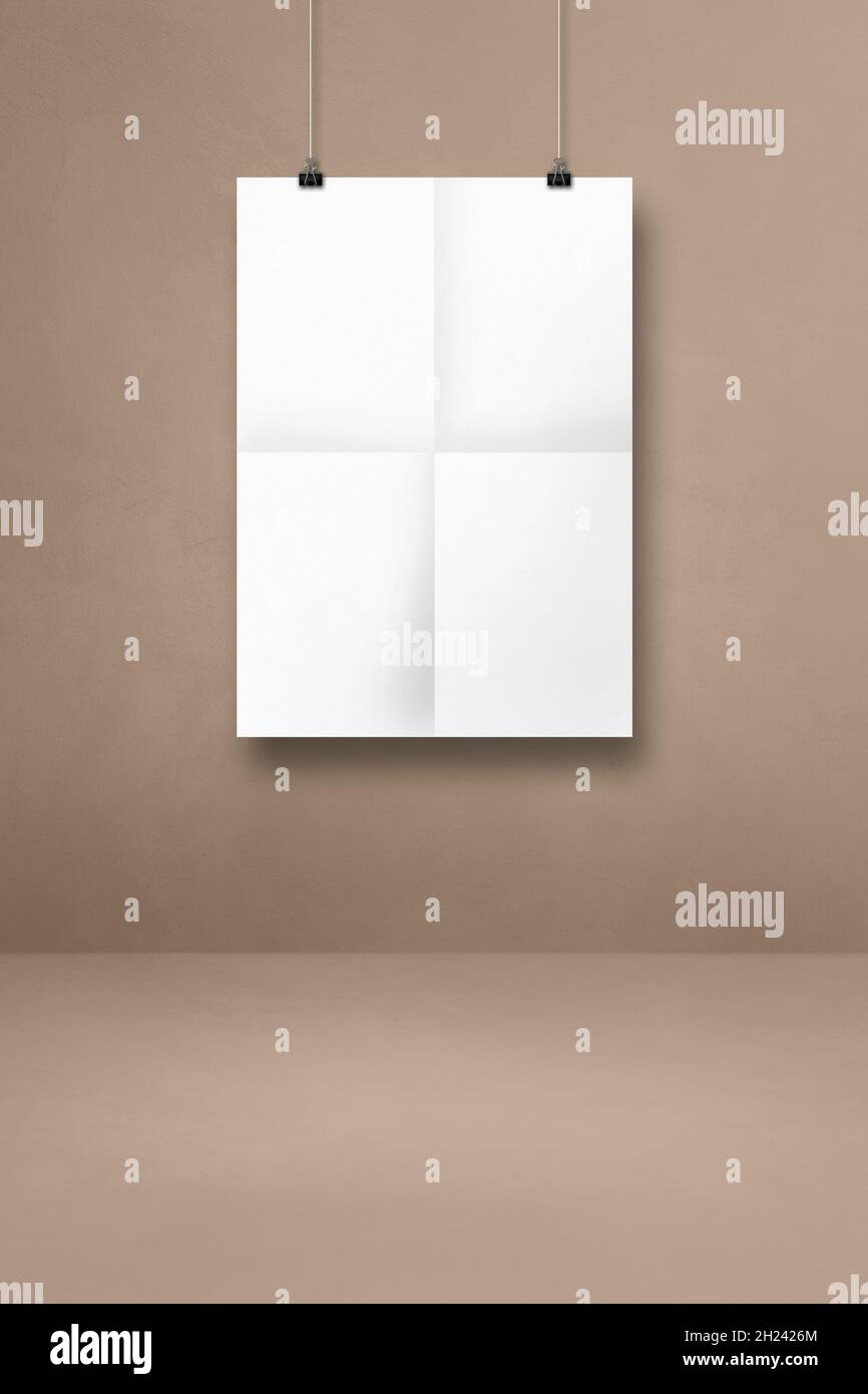 White folded poster hanging on a beige wall with clips. Blank mockup ...