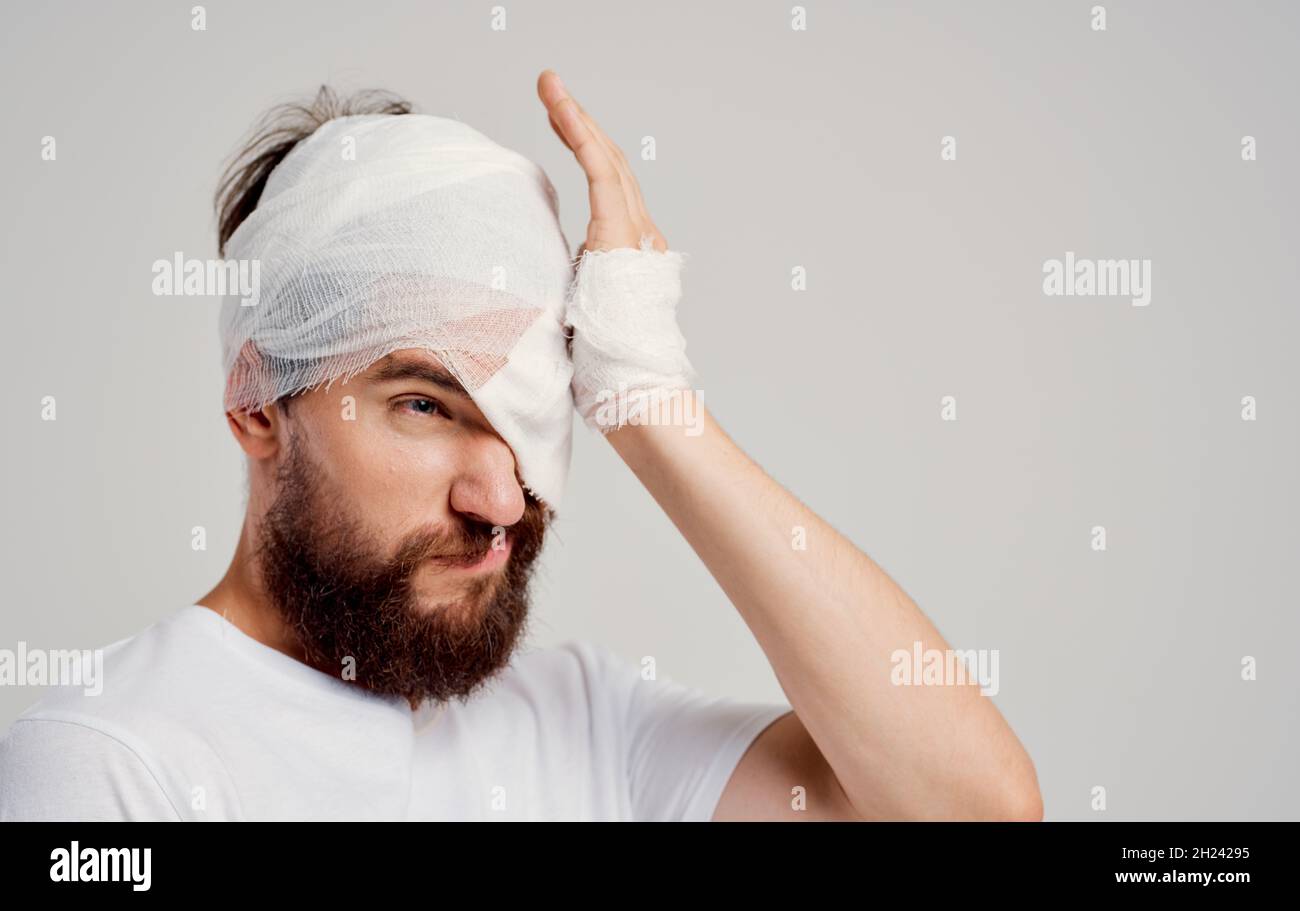 male patient with bandaged head and eye hospitalization isolated ...