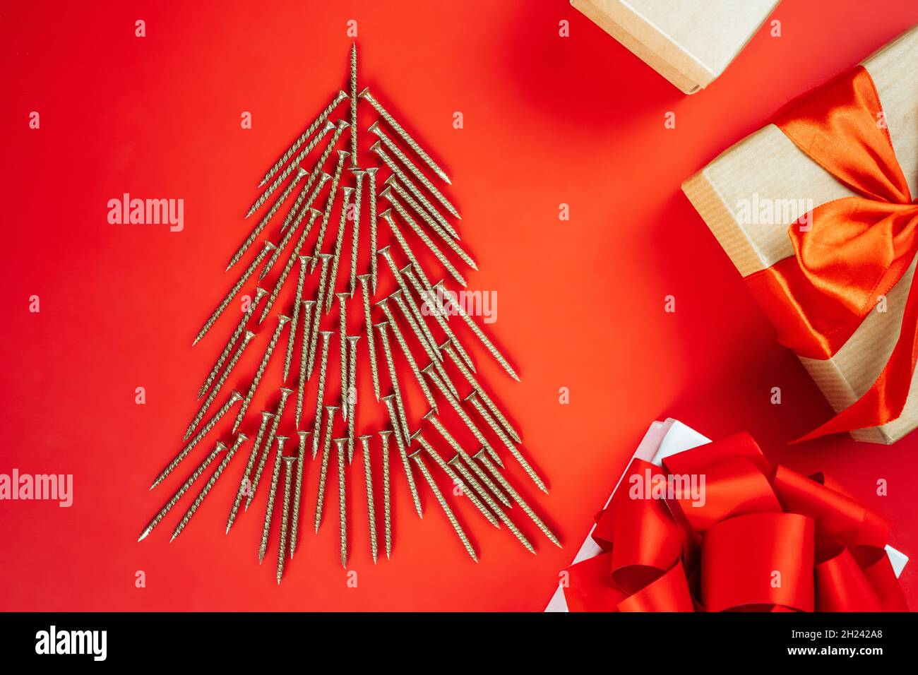 Long golden self-tapping screws, laid out in shape of Christmas tree ...