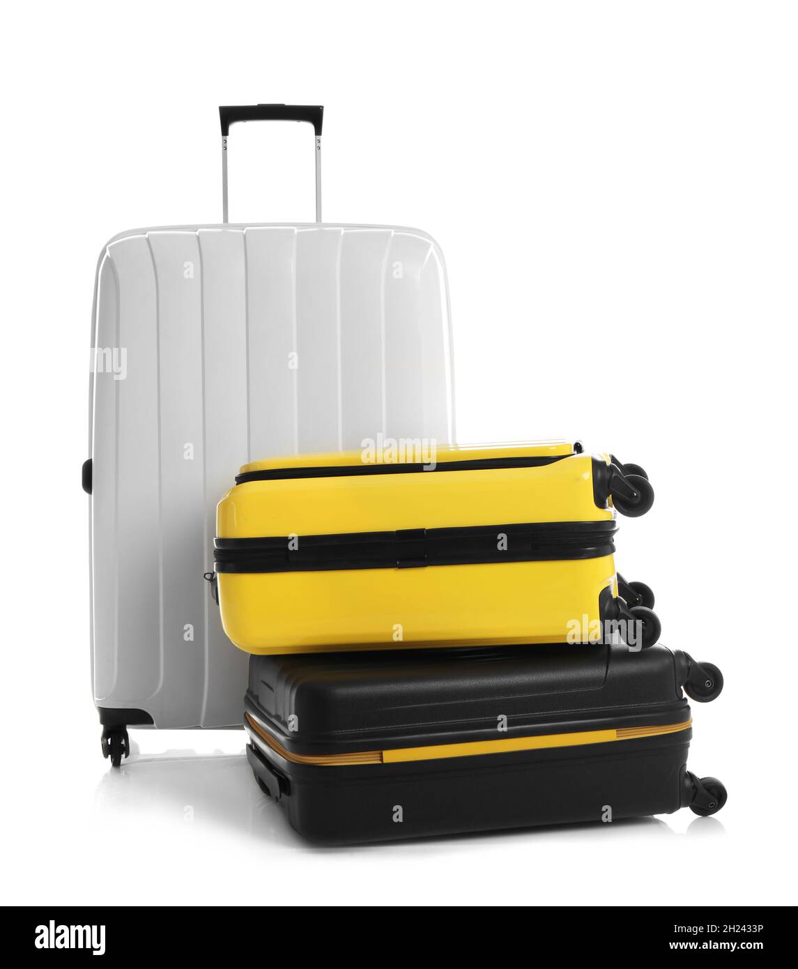 Modern suitcases for travelling on white background Stock Photo - Alamy