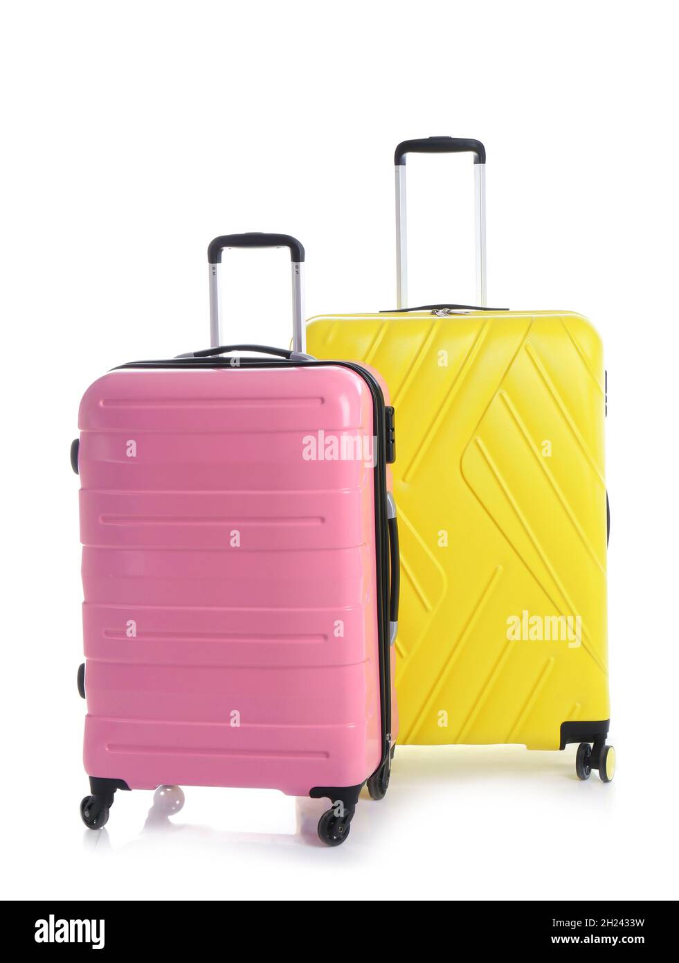 Modern suitcases for travelling on white background Stock Photo - Alamy