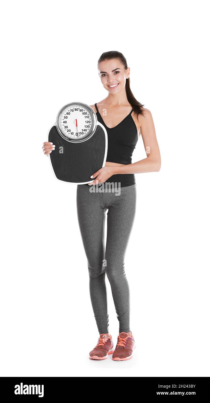 Happy young woman with scales on white background. Weight loss ...