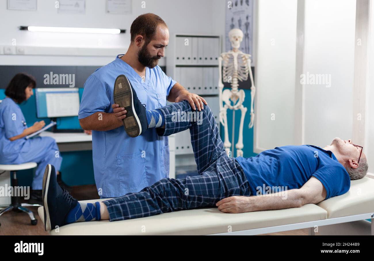 Adult with knee injury receiving osteopathic assistance for physical ...