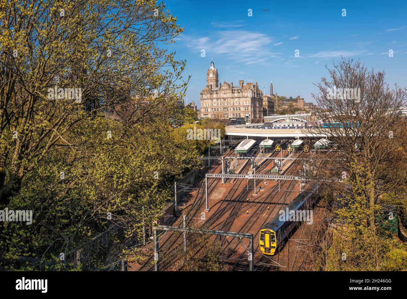 Edinburgh Waverley railway station with trains against Clock Tower ...
