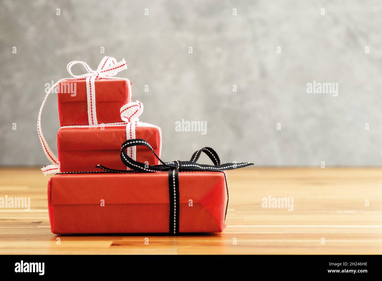 Stack of gift boxes on the wooden table. Love, gift and present concept ...