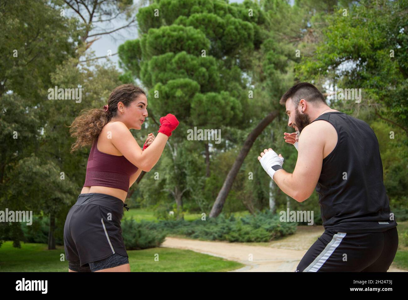 Female boxer fighting with young caucasian man outdoor Stock Photo - Alamy