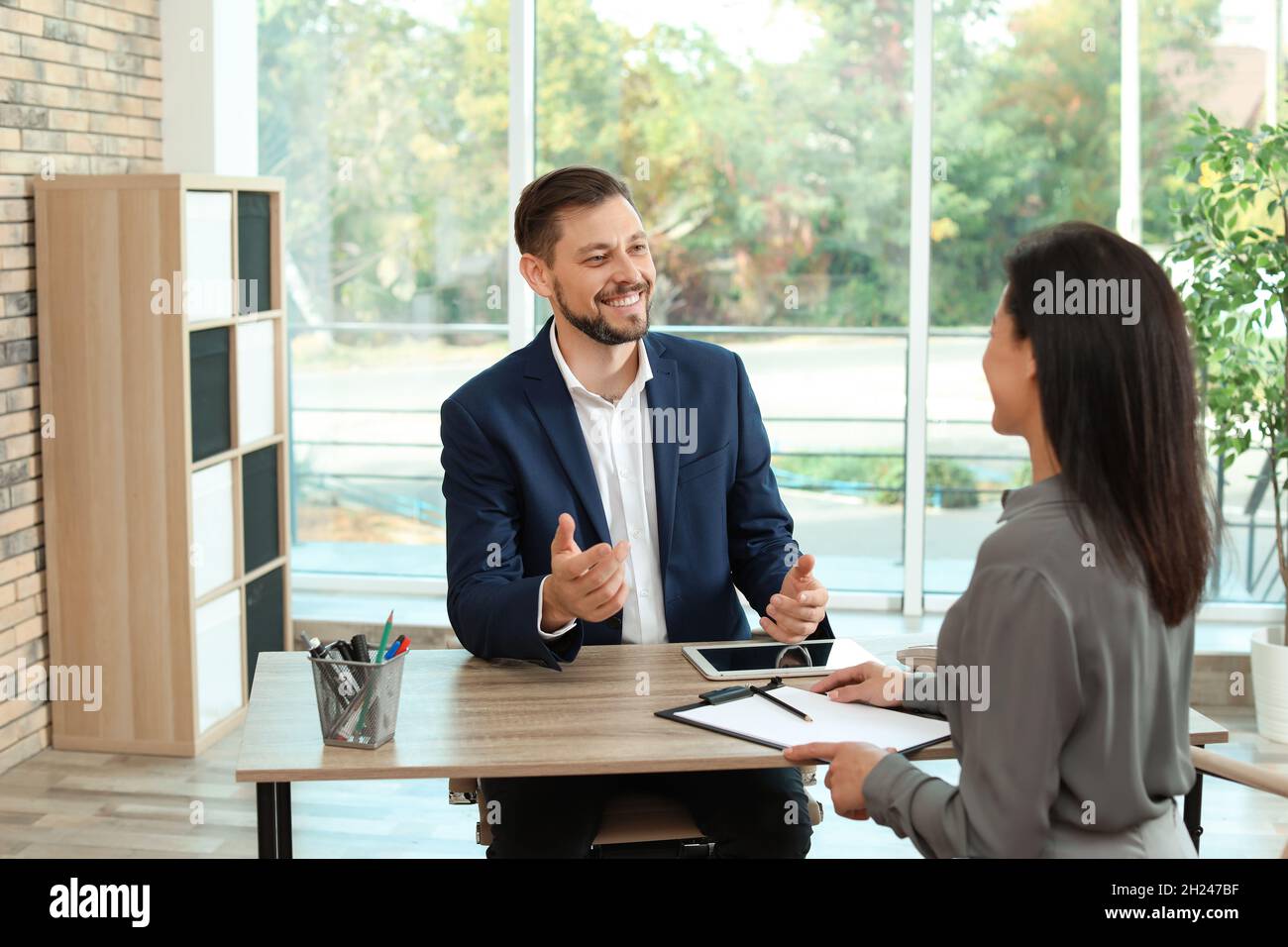 Human resources manager conducting job interview with applicant in office Stock Photo - Alamy