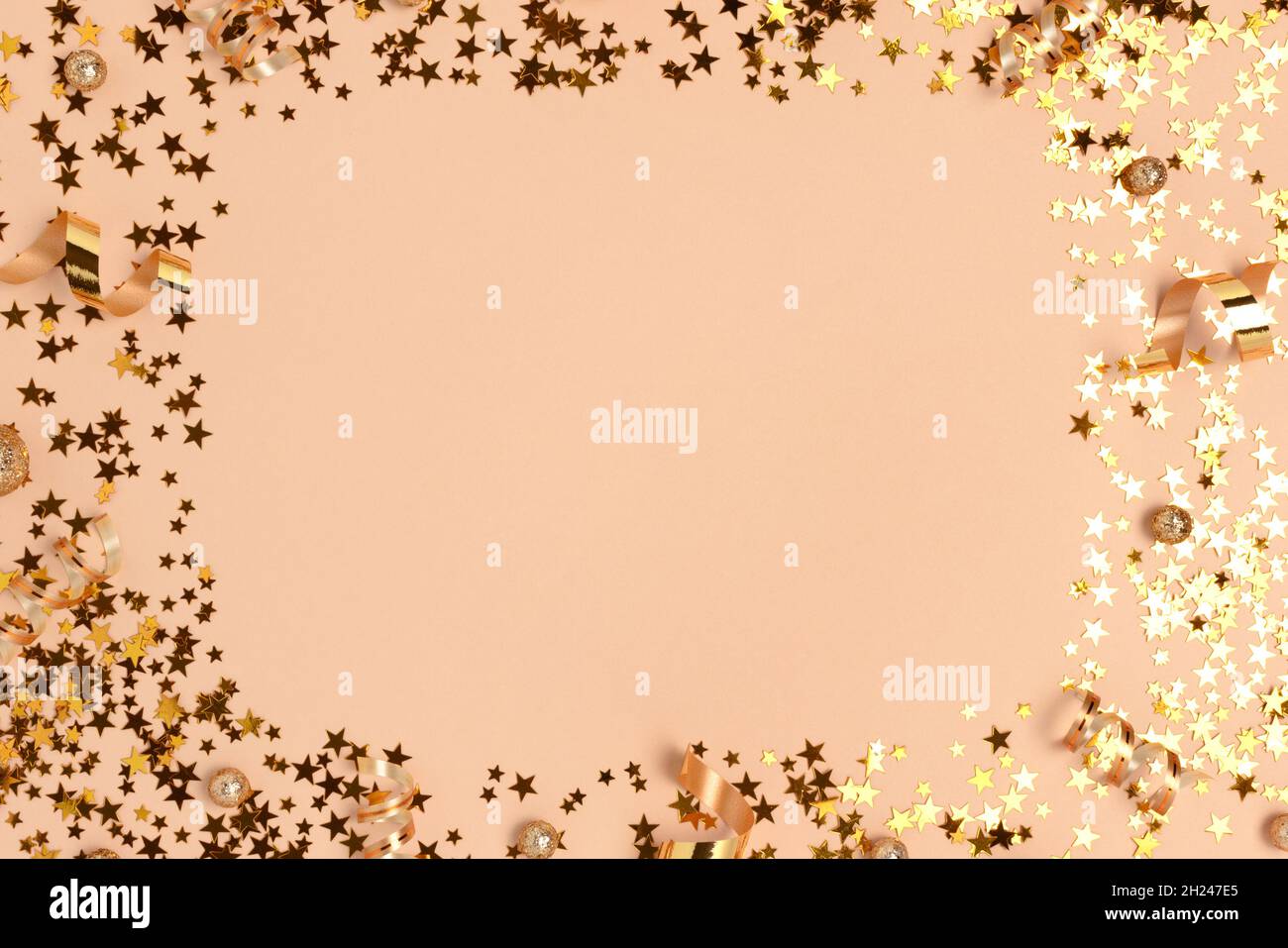 Border frame made of gold colored confetti on a beige background Stock ...