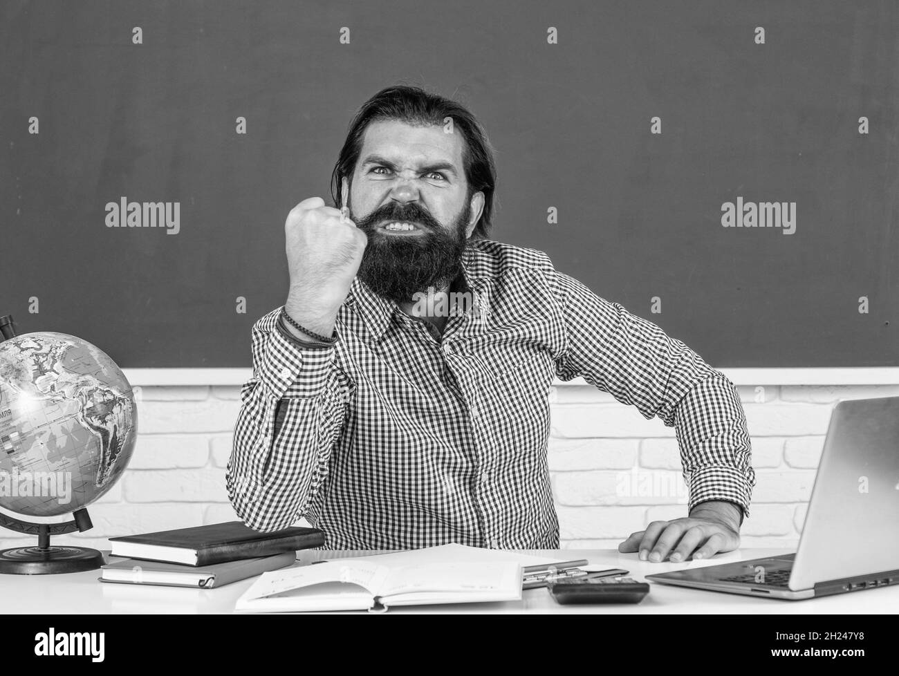 angry man threatened with his fist in a fit of rage, school teacher ...