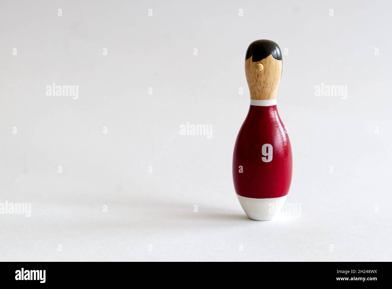 Wooden bowling kegel or a pin painted as sports team member isolated on ...
