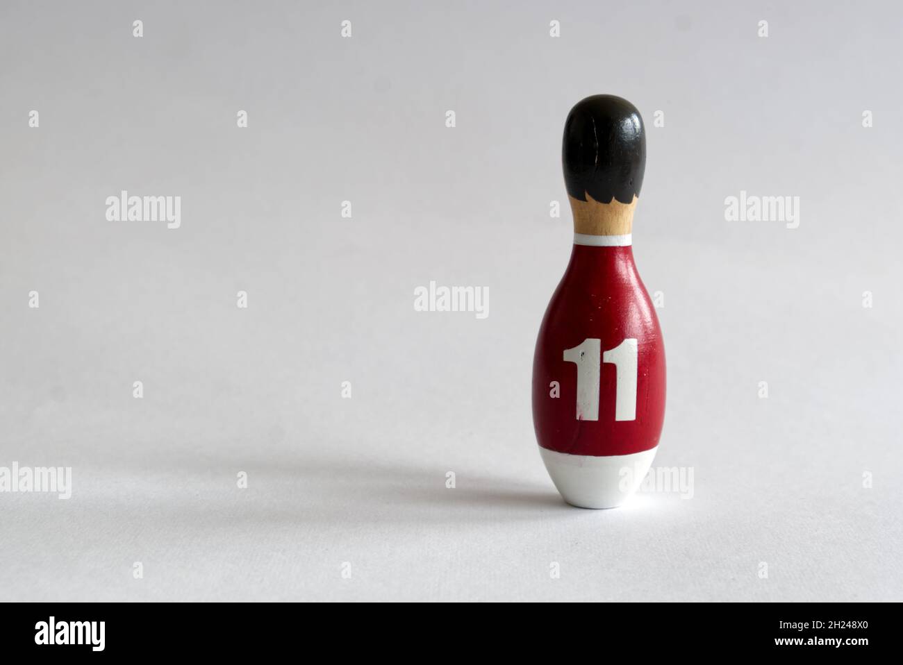 Wooden bowling kegel or a pin painted as sports team member isolated on ...