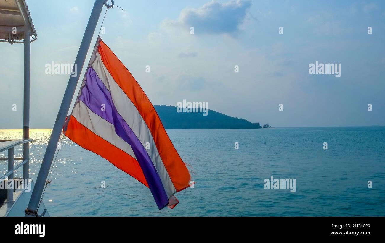 Thai flag over the passengers at a port in Ko Pha-ngan, Thailand Stock ...