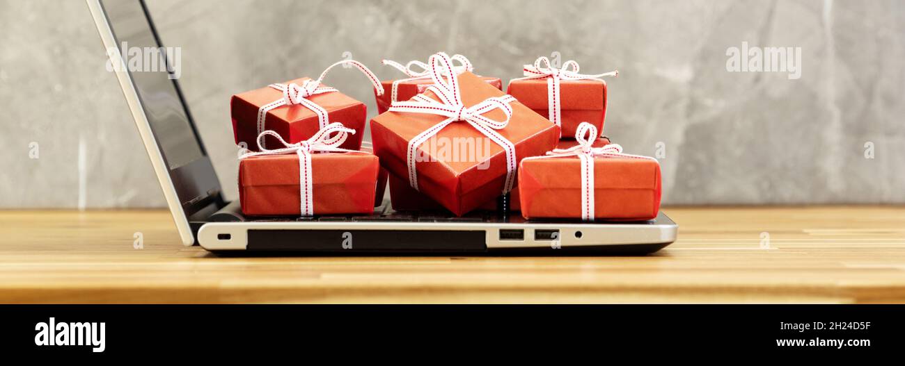 Panoramic photo of multiple gift boxes on laptop. Love, gift and ...