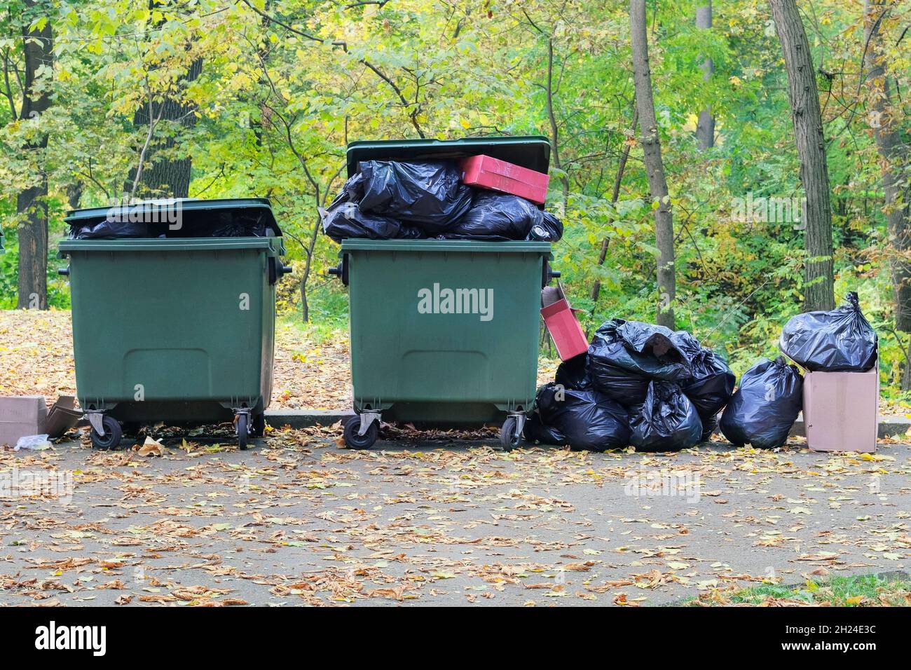 Dumpsters being full with garbage in the park. Garbage waste lots junk ...