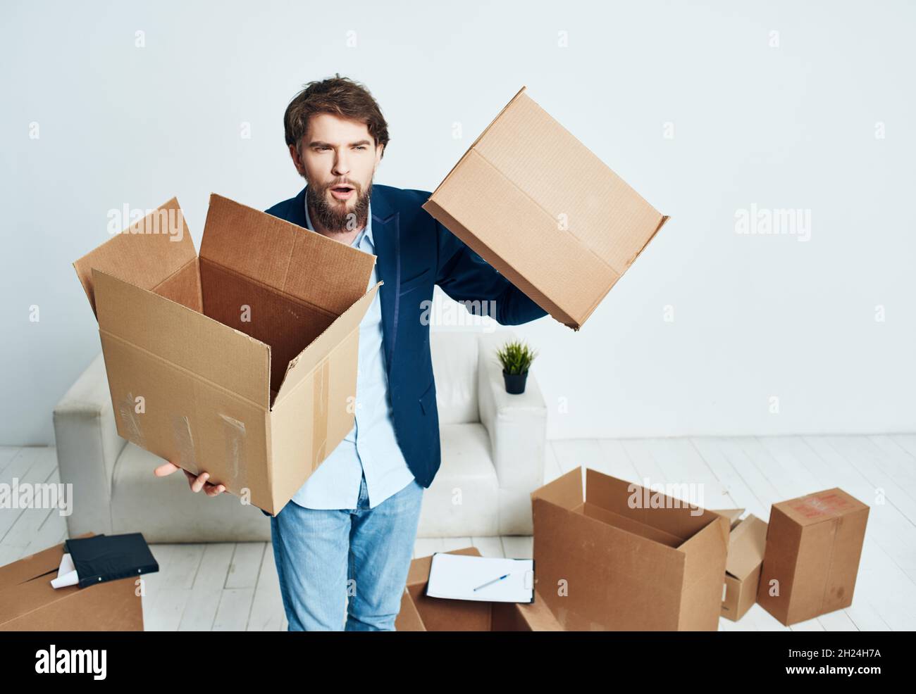 male manager unpacking boxes office moving Stock Photo - Alamy
