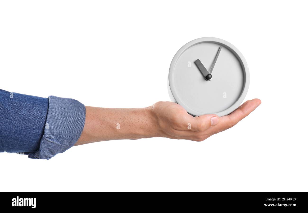 Young man holding clock on white background. Time management Stock ...