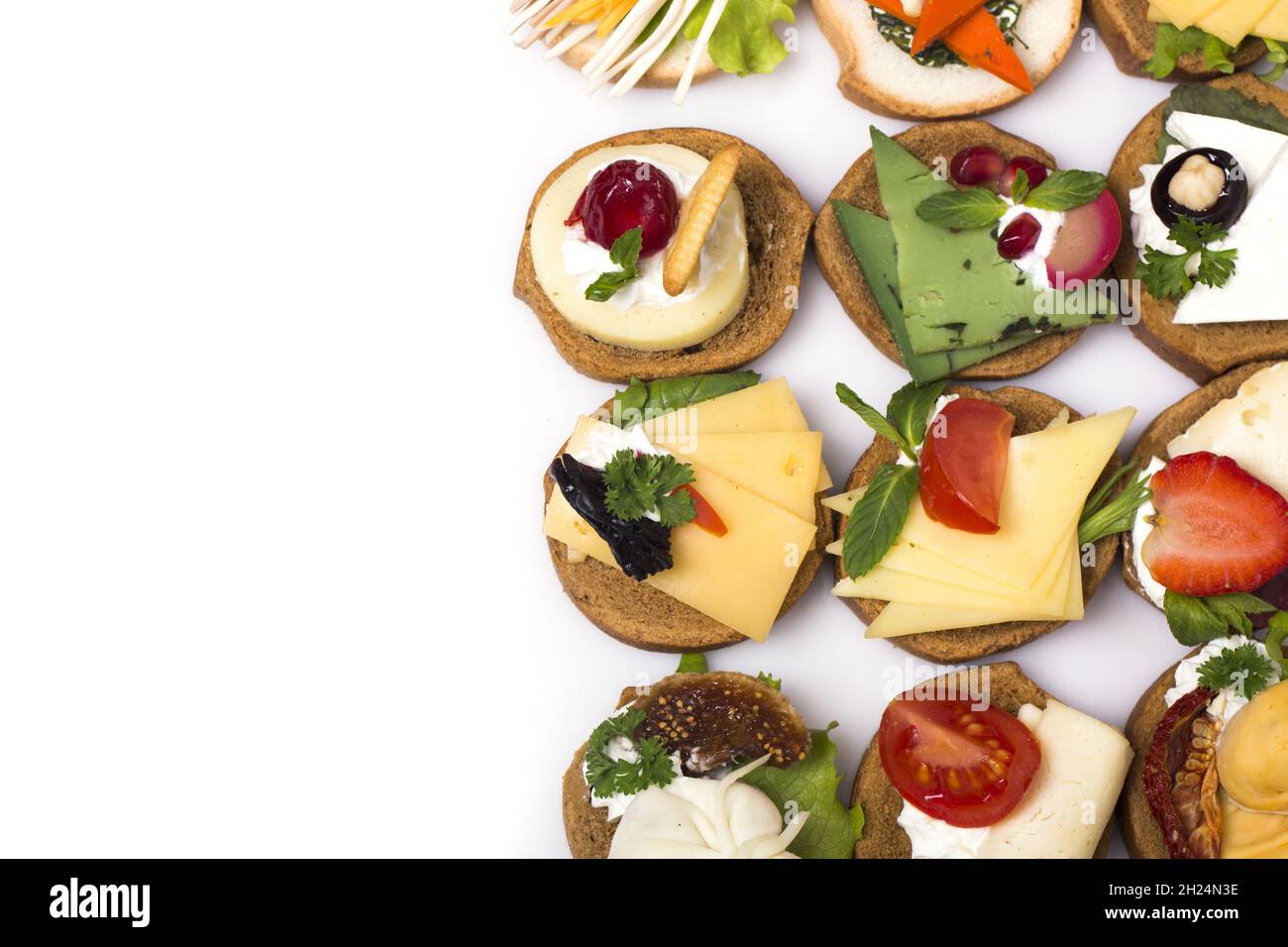 Shot of delicious different canapes with feta cheese isolated on white ...