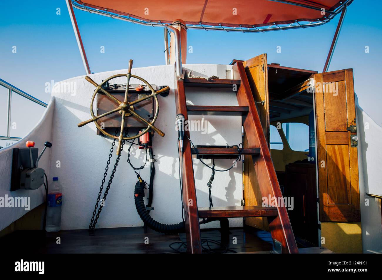Traditional sailboat with a wooden steering wheel and ladder Stock ...