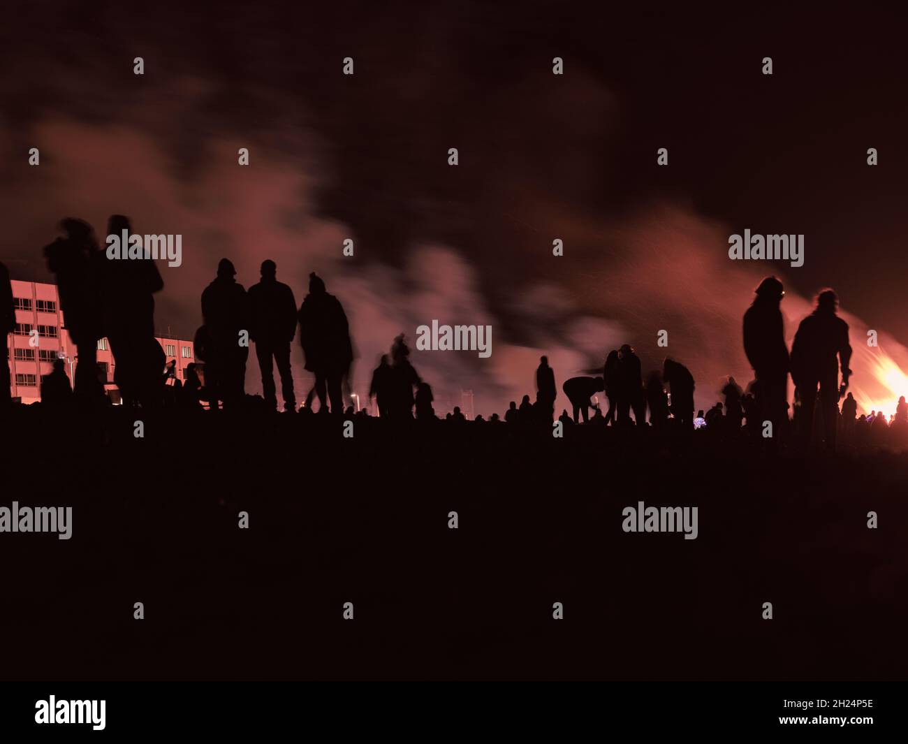 Silhouettes / figures crowd on the beach celebrating the annual ...
