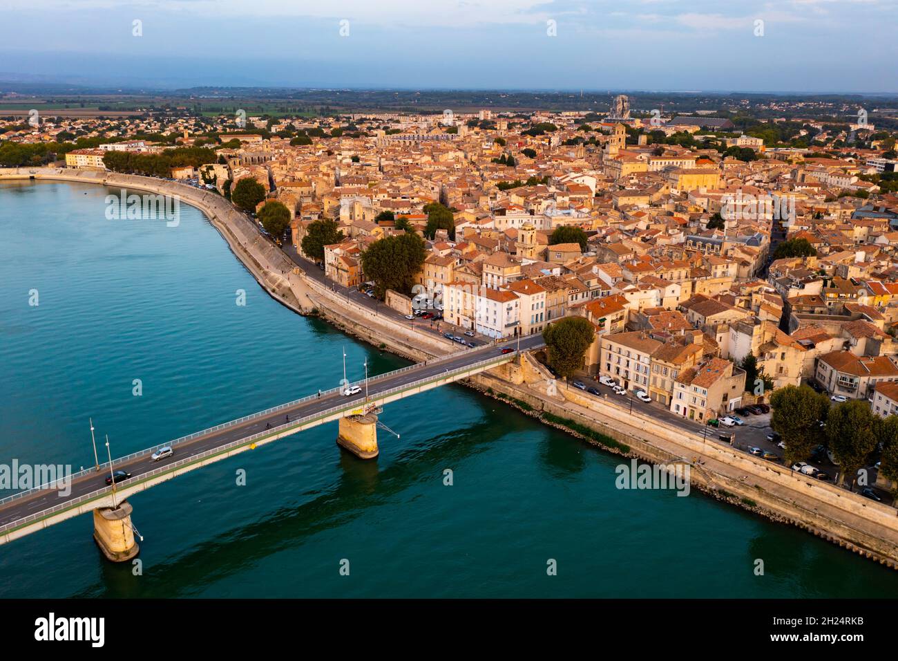 Cityscape of Arles, southern France. Tiled roofs of buildings and Rhone ...