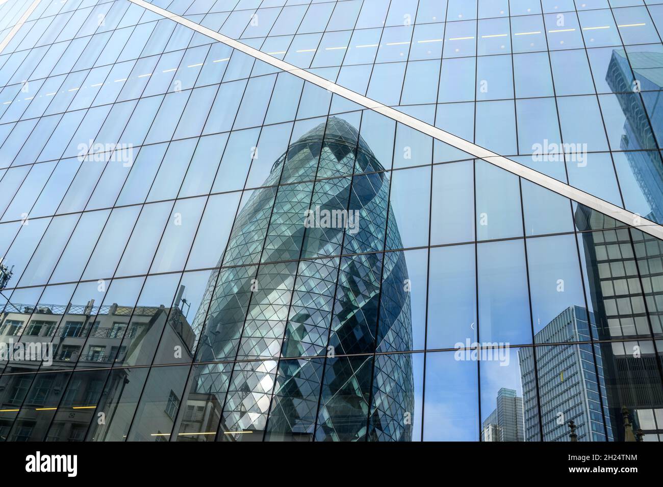 The Gherkin and other buildings reflected in the glass facade of The ...