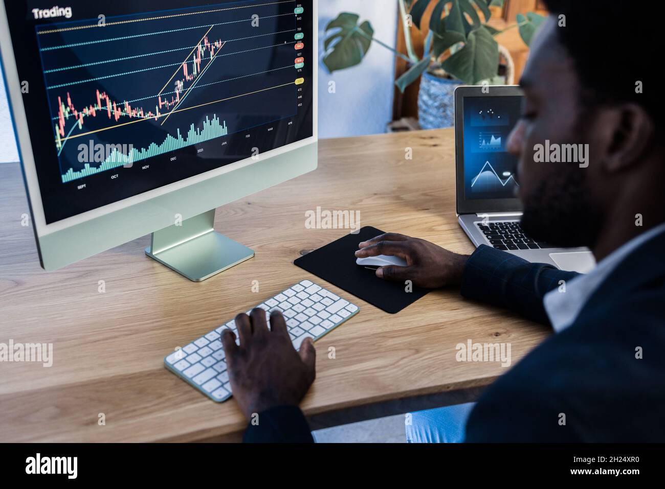 African trader studying stock market at home - Focus on computer screen ...