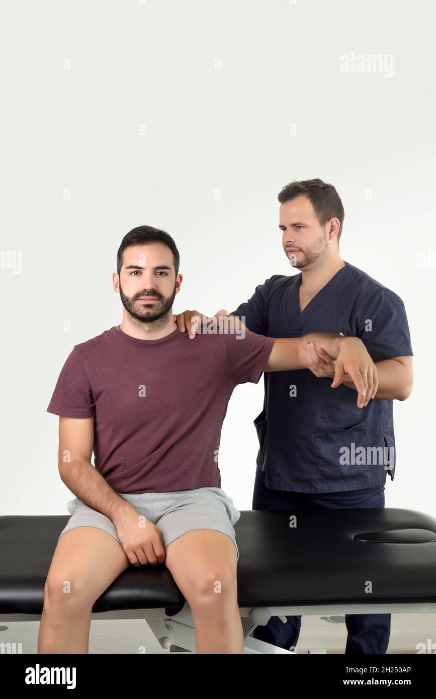 Physiotherapist performing arm mobility exercises on a patient Stock ...