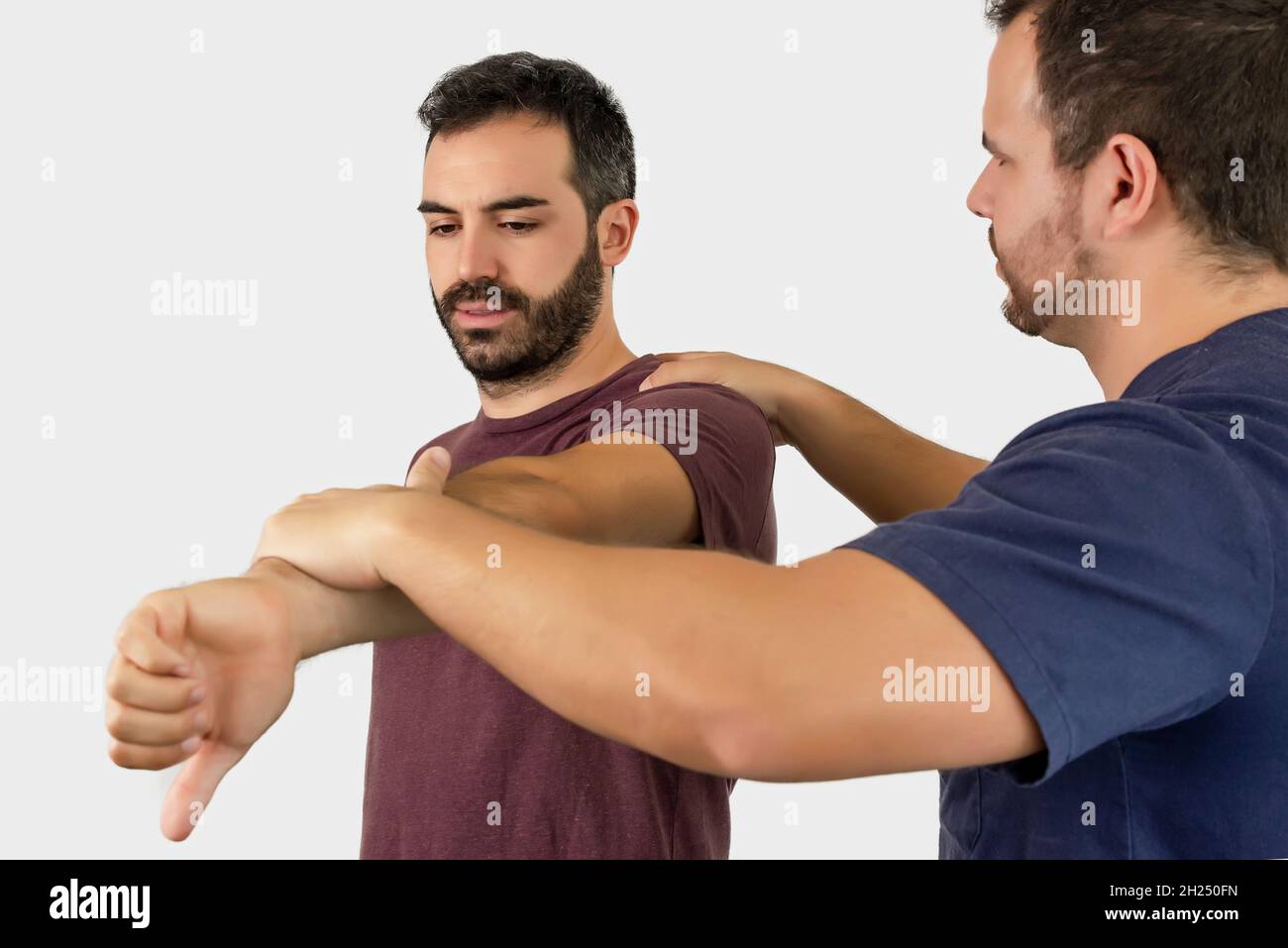 Physiotherapist performing arm exercises with the patient Stock Photo ...
