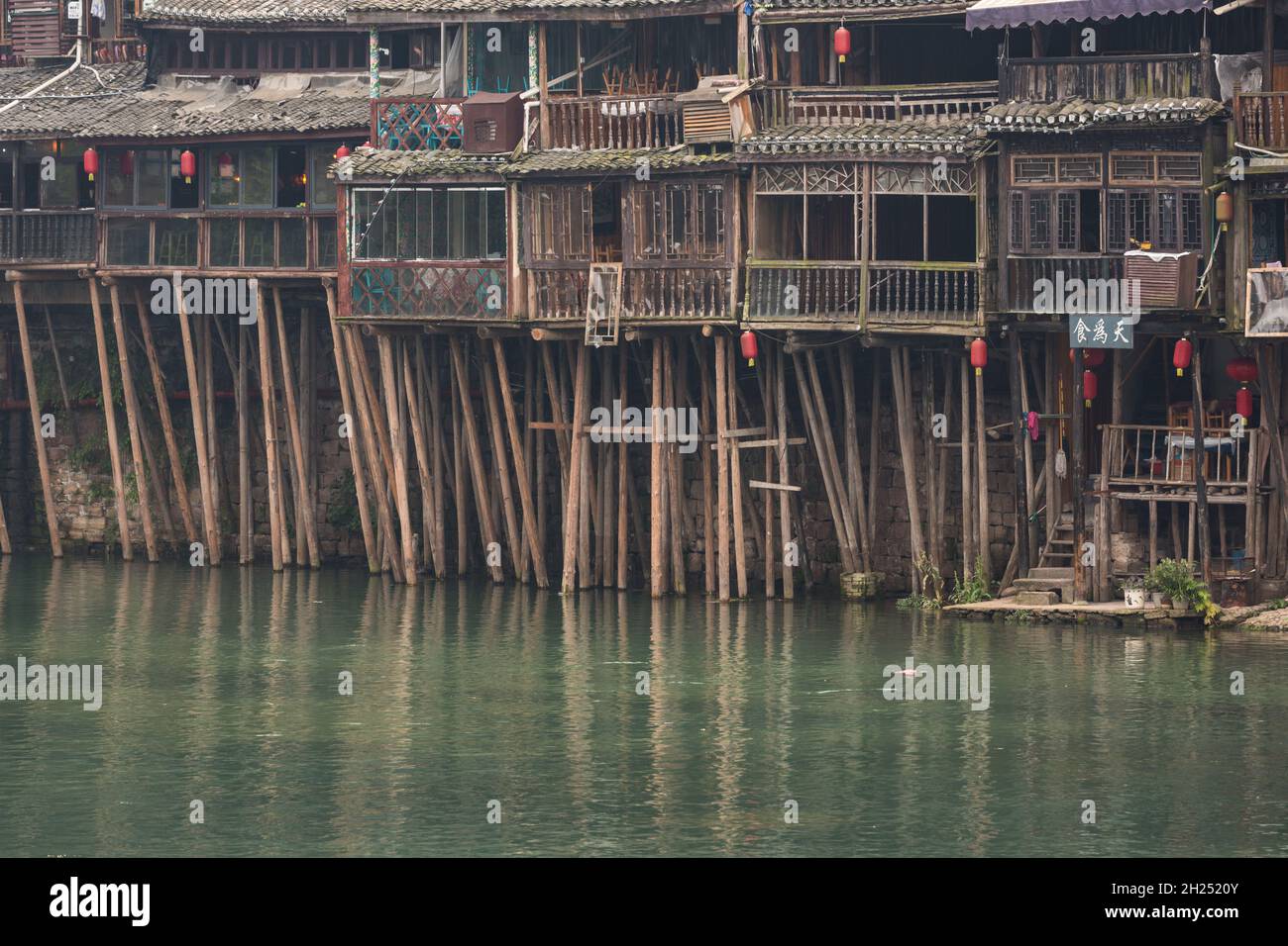 Traditional Diaojiao houses on stilts along the banks of the Tuojiang ...