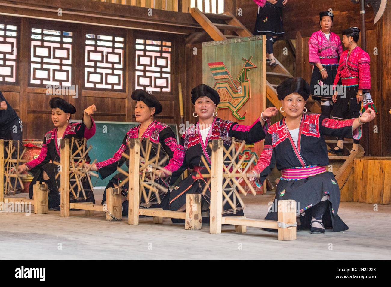 Red Yao ethnic minority women demonstrate spinning thread for weaving ...