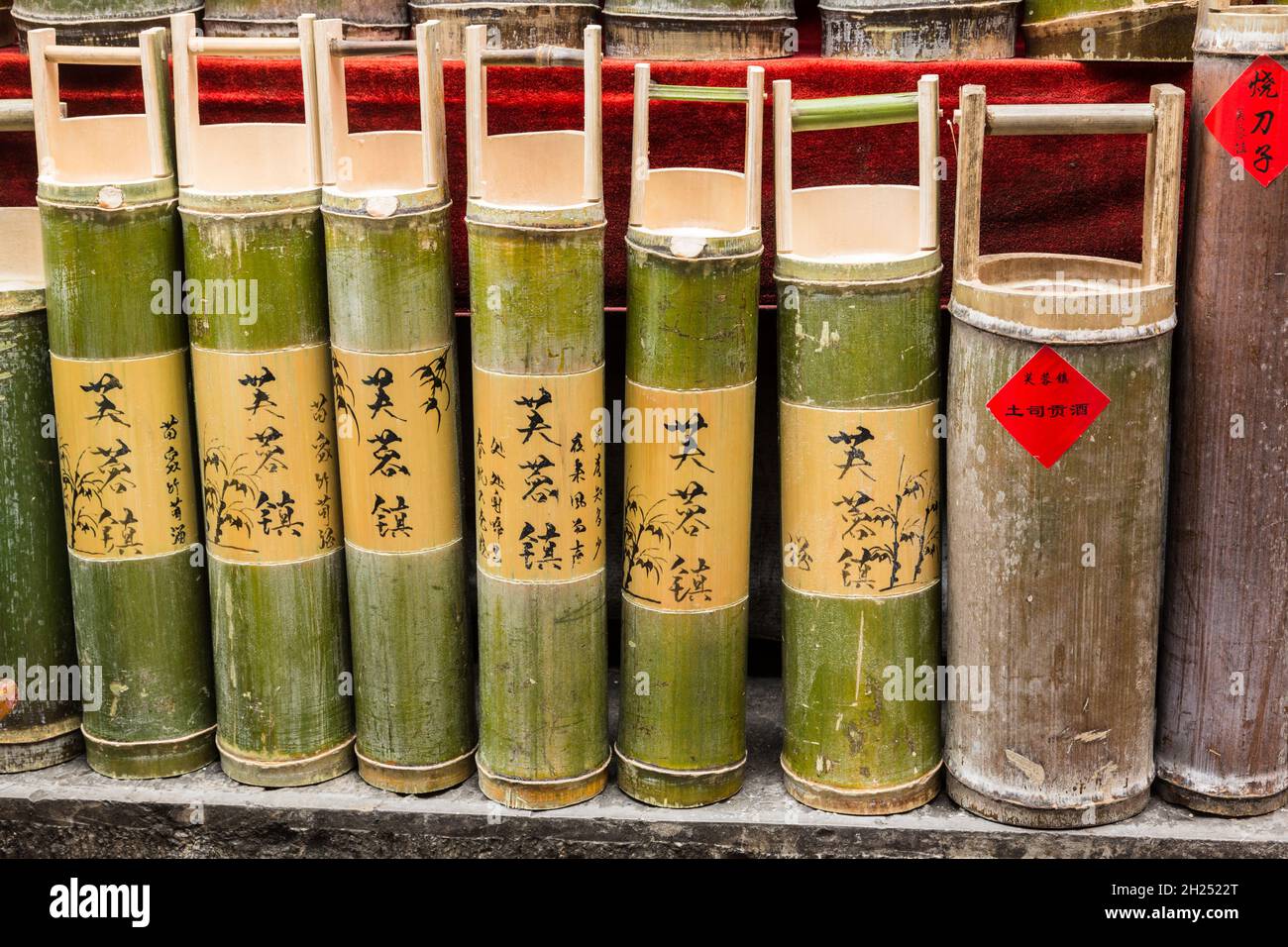 Bamboo containers of rice wine for sale on the street in the ancient ...