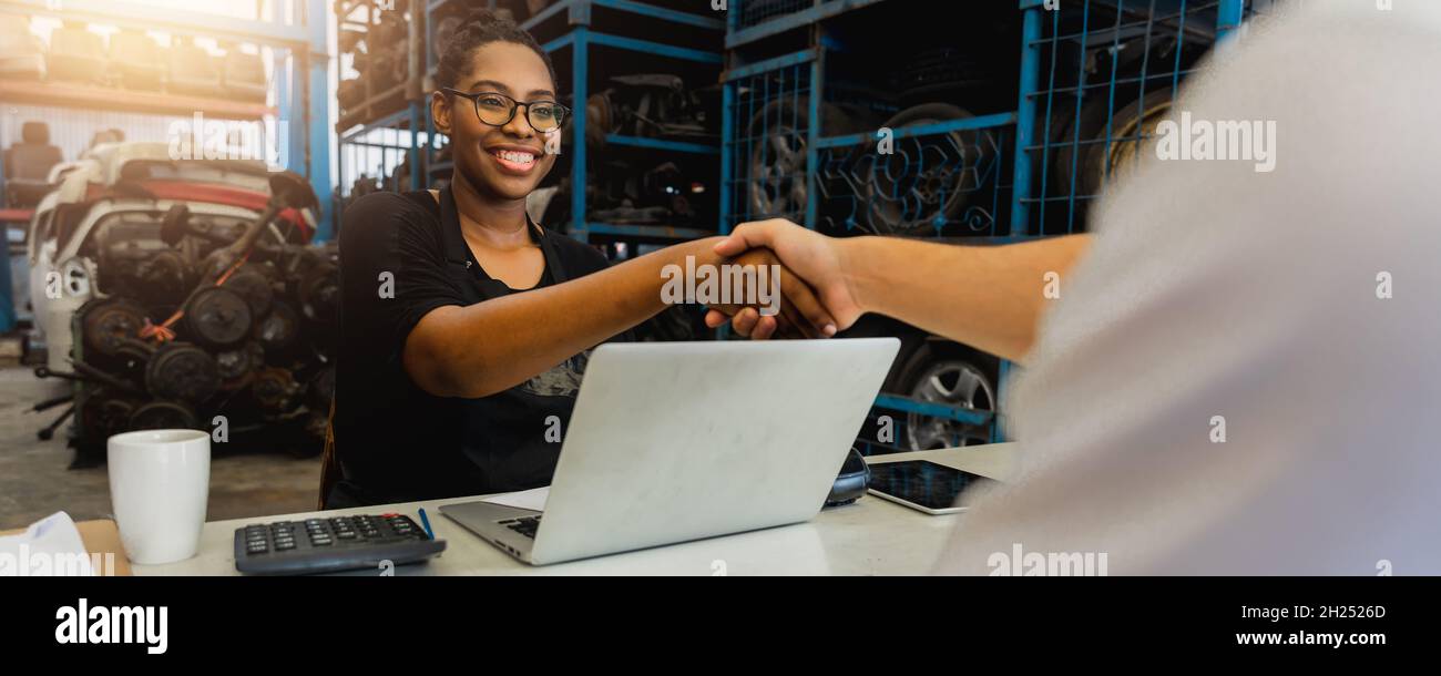 Old auto parts seller shake hand with customer after successful selling ...