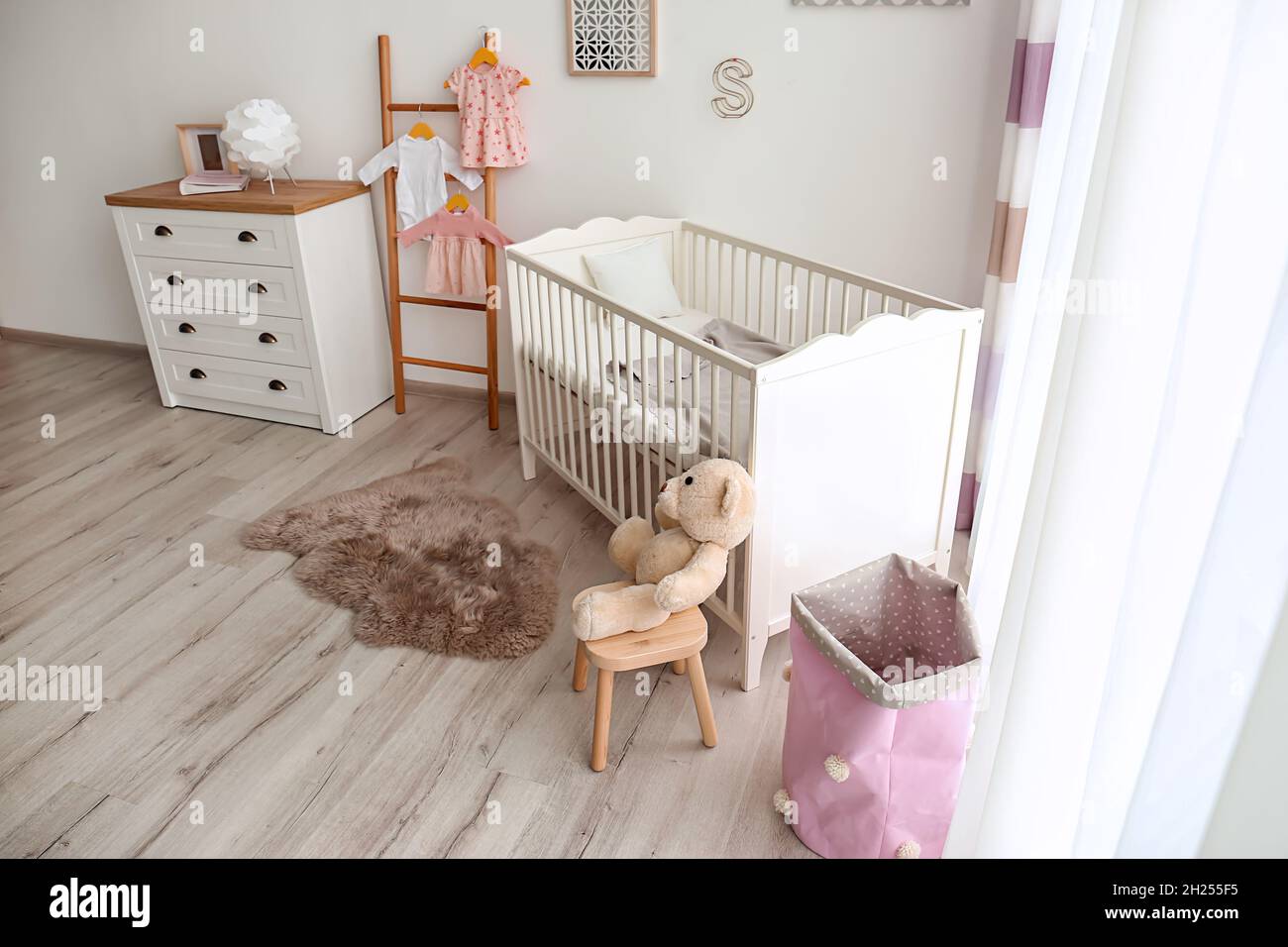 Cozy baby room interior with crib Stock Photo - Alamy