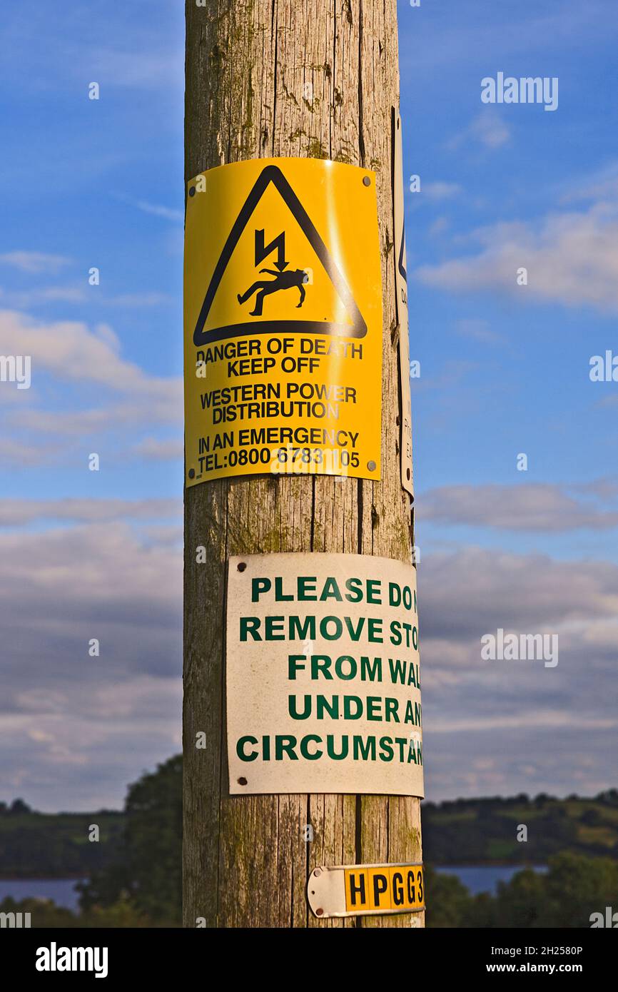 Overhead electricity network warning signs Stock Photo - Alamy