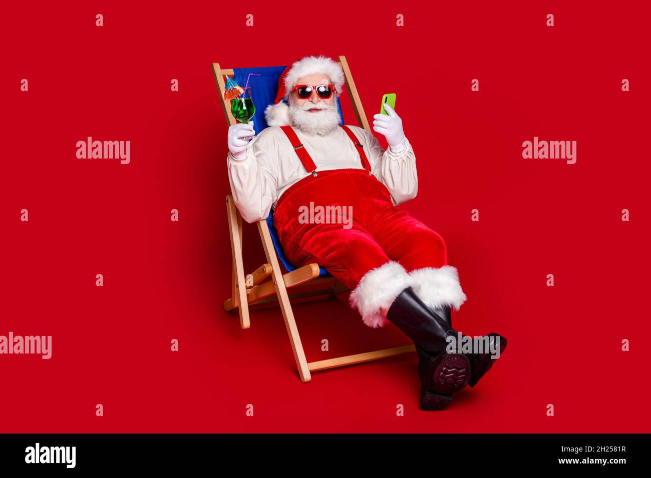 Photo of pretty funny retired man wear santa claus costume sitting ...