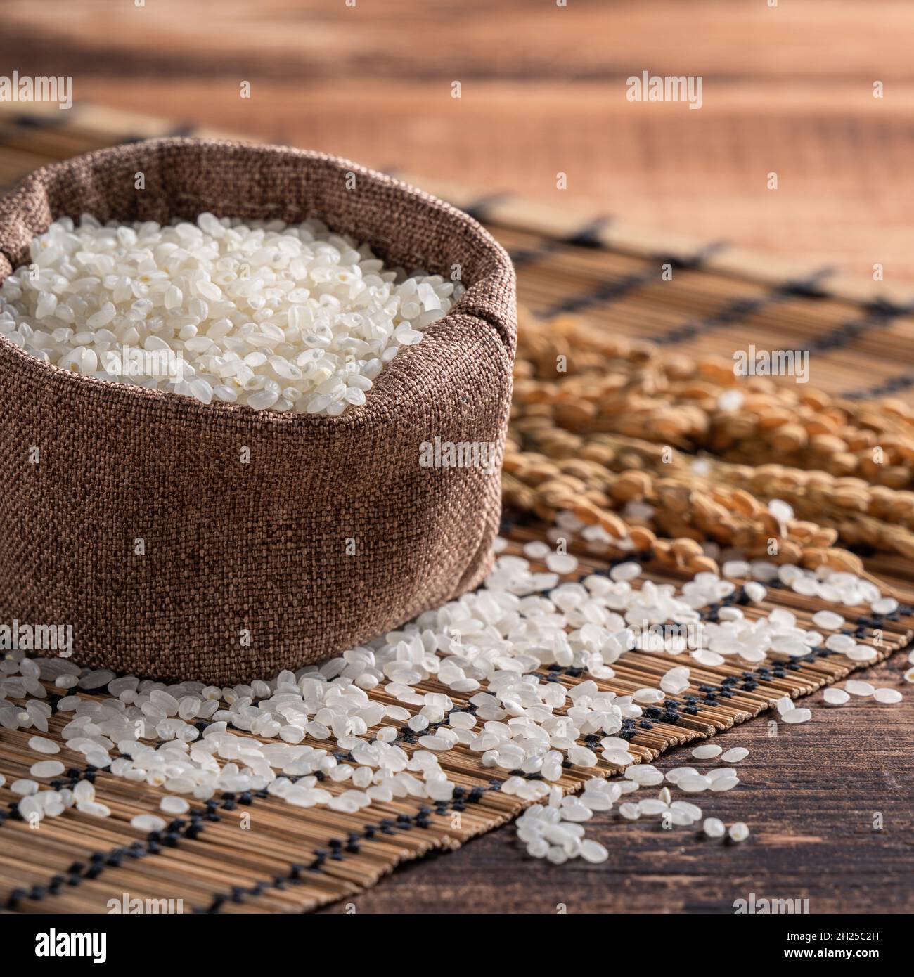 Raw white polished milled edible rice on wooden table background in a ...