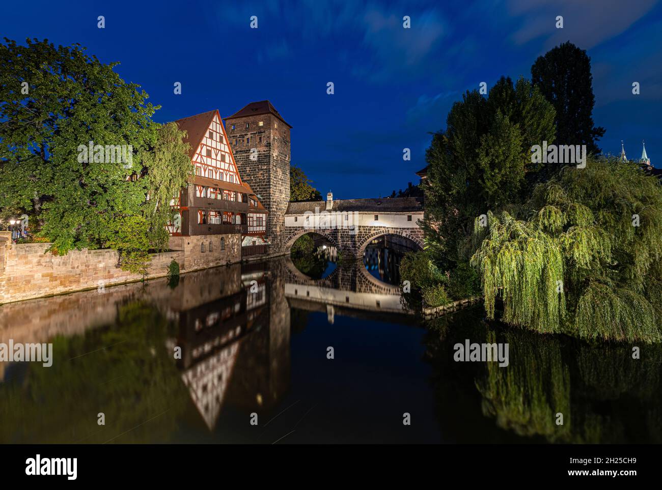 Beautiful old bridge with medieval tower and half timbered house along ...