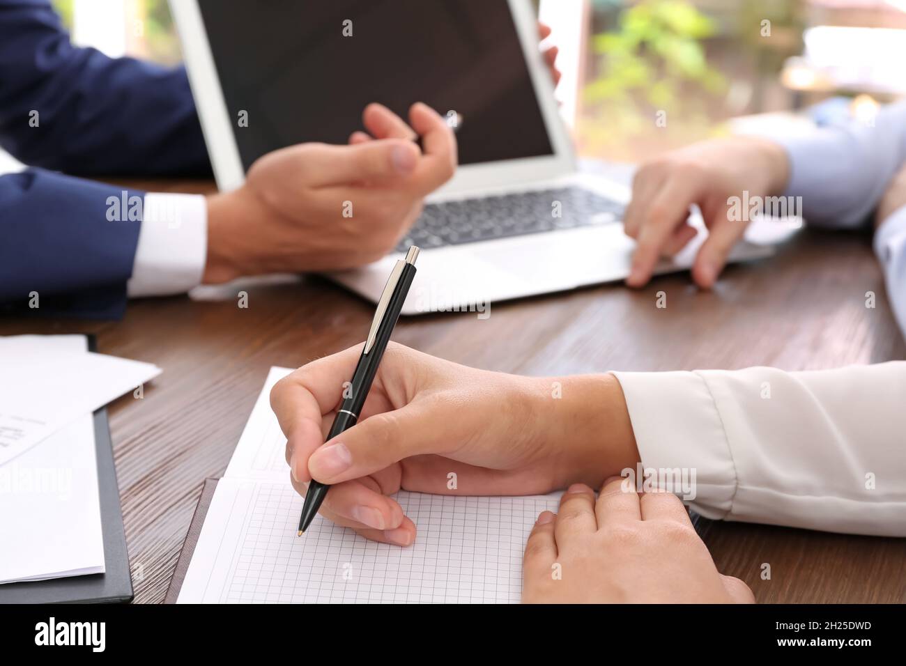 Lawyer working with clients at table in office, focus on hands Stock ...