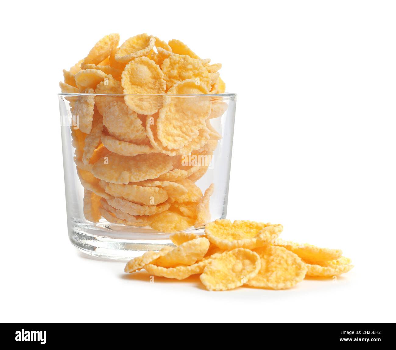 Glass with crispy cornflakes on white background Stock Photo - Alamy