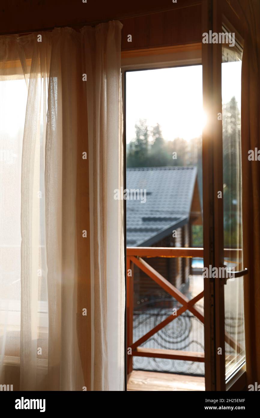Open balcony door with curtain in apartment Stock Photo - Alamy