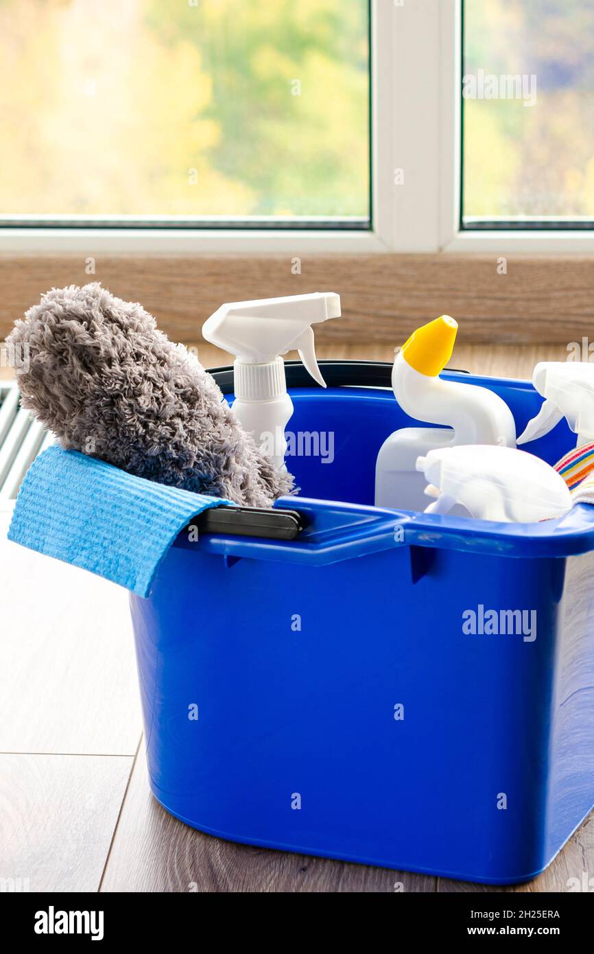 Cleaning service. Bucket with sponges, chemicals bottles and mopping ...