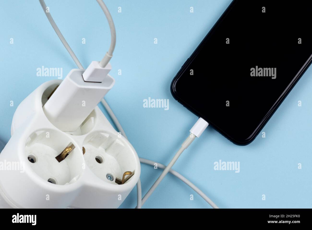 Close up photo of a hand charging mobile phone Stock Photo - Alamy