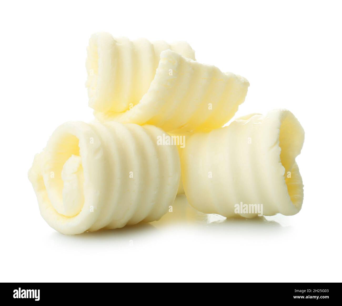 Tasty butter curls on white background Stock Photo - Alamy
