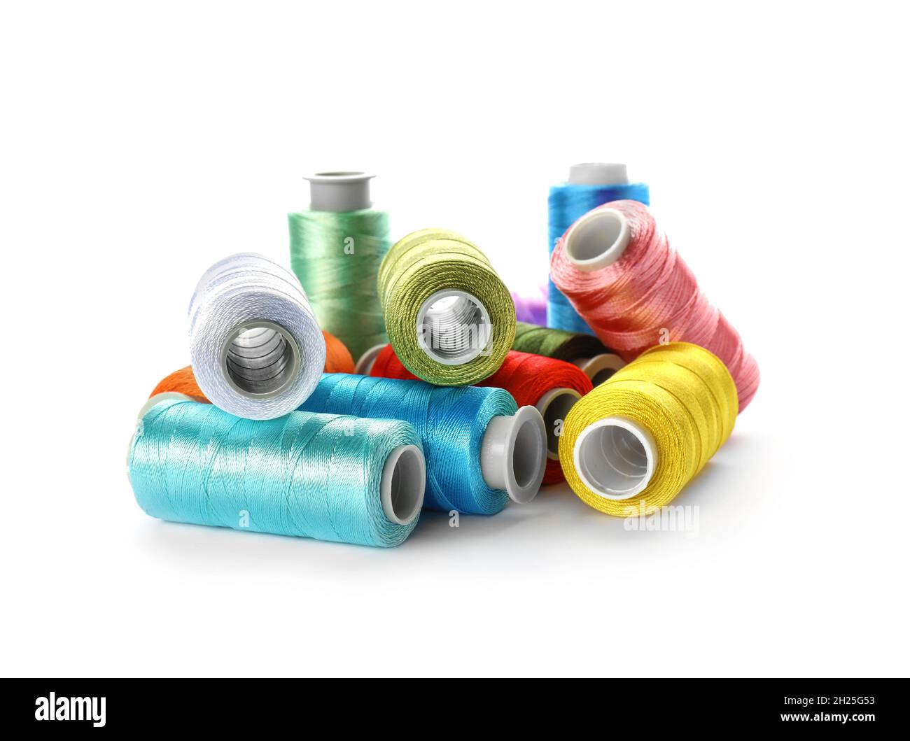 Color sewing threads on white background Stock Photo - Alamy